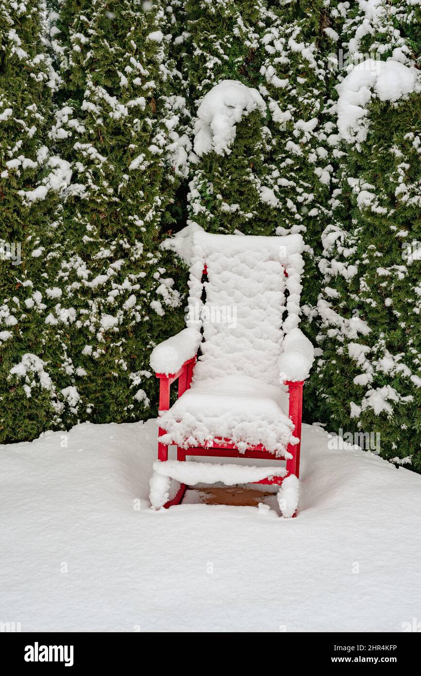 Single lawn chair covered in snow on a deck Stock Photo - Alamy