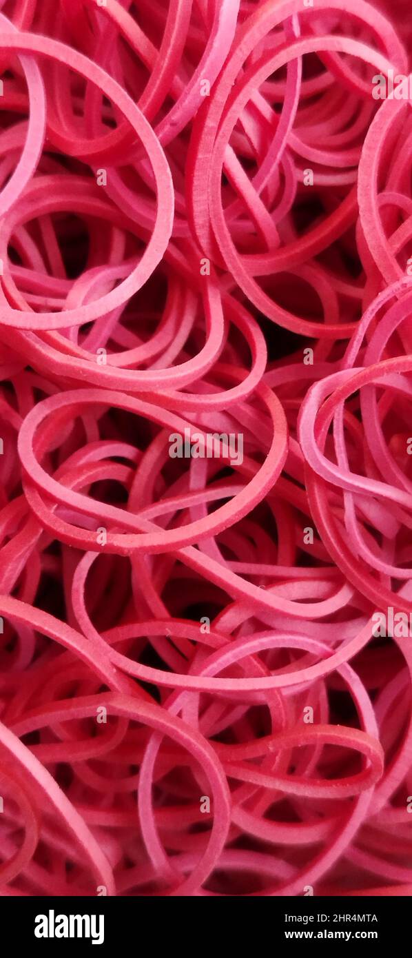 Red colour rubber bands background Stock Photo - Alamy