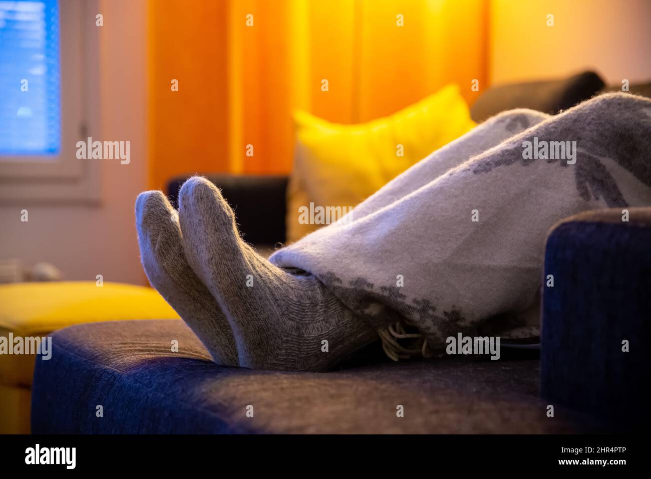 Close-up shot of the feet of a person sitting on the couch Stock Photo ...
