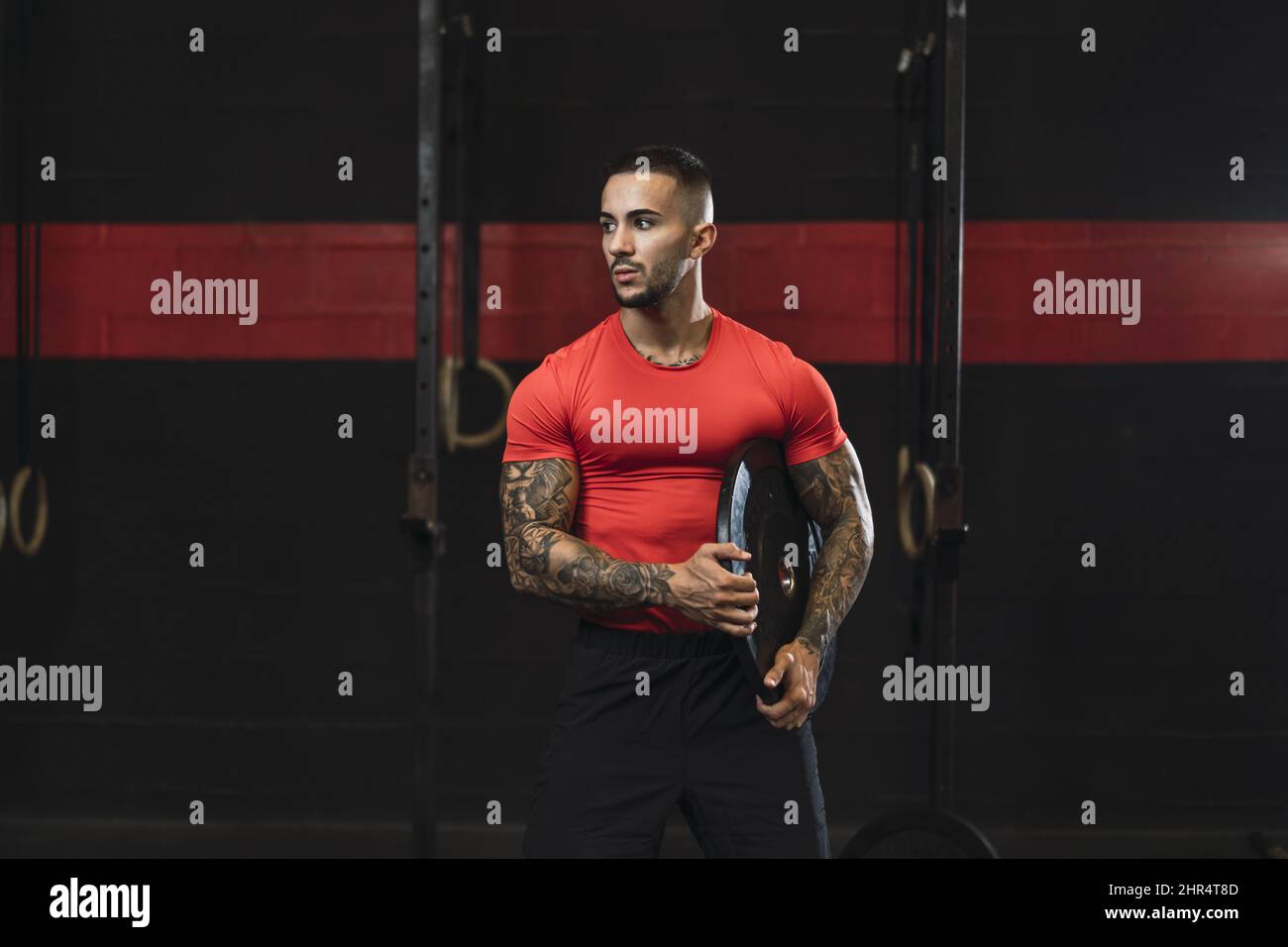 Closeup shot of an athlete in the gym in a red workout shirt Stock ...