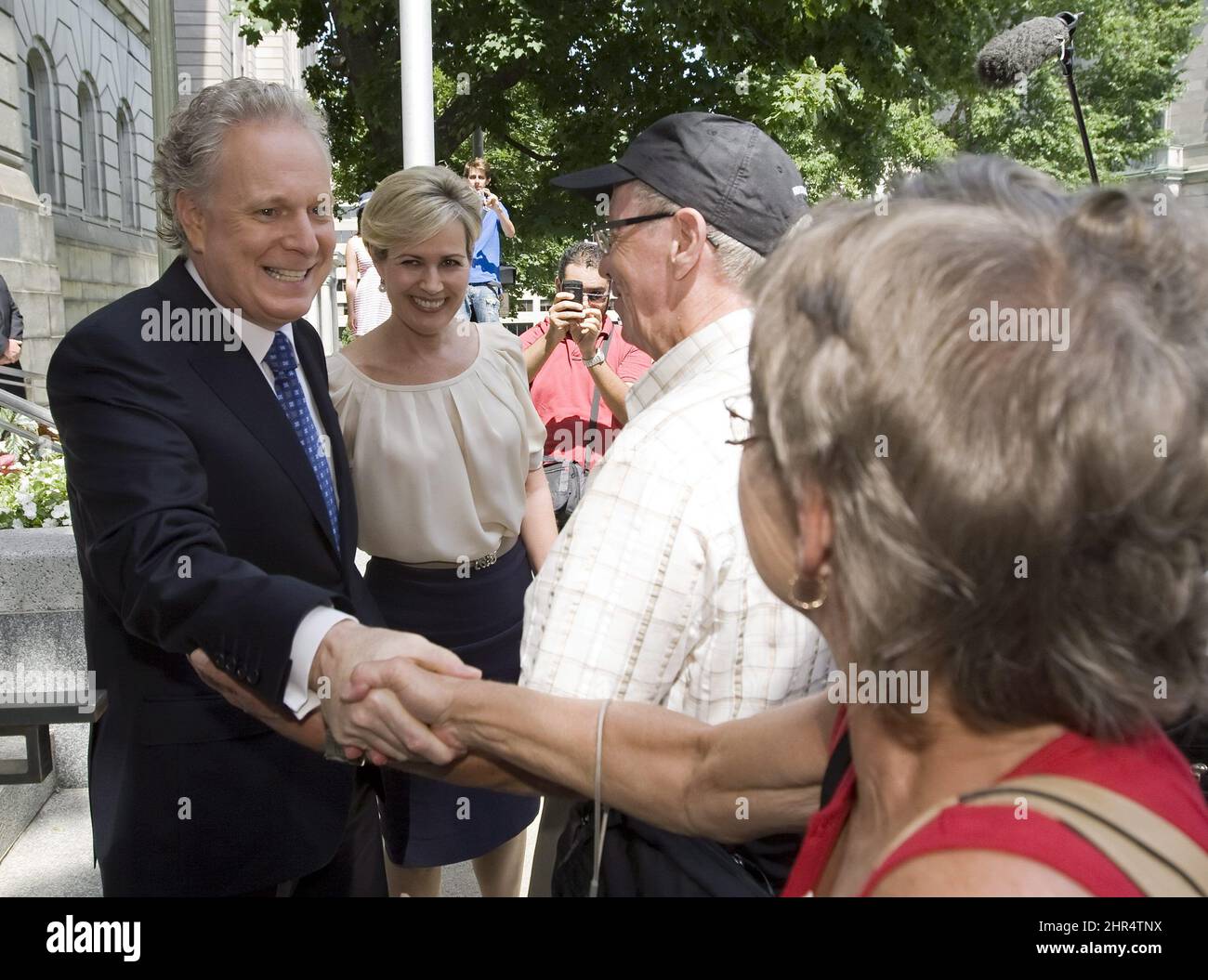 Quebec Premier Jean Charest shakes hands with wellwishers after meeting ...