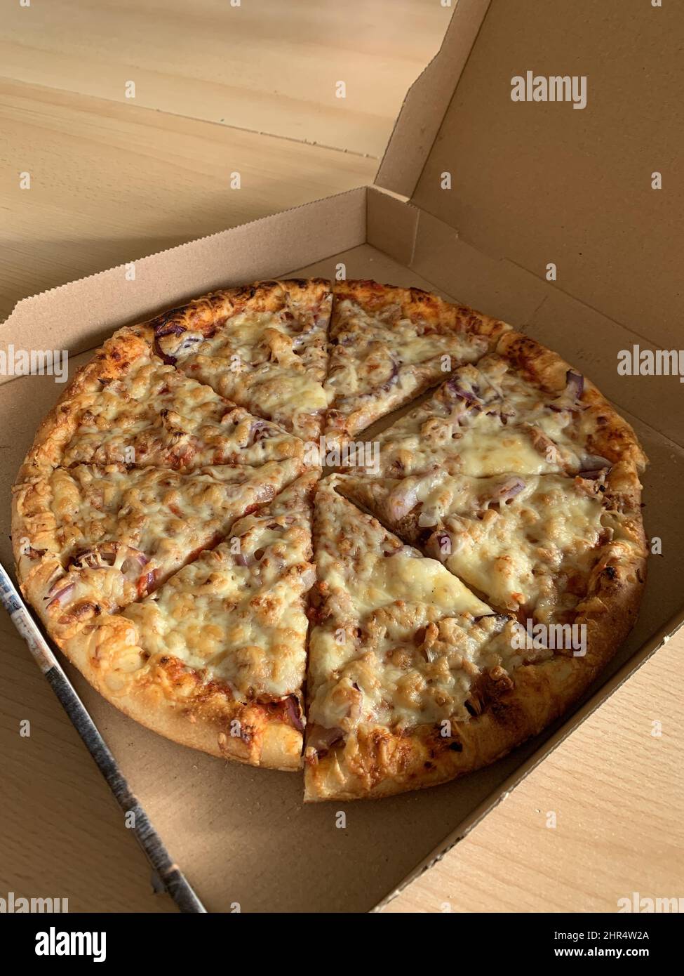 Closeup of a cheese pizza with eight slices inside a box Stock Photo ...