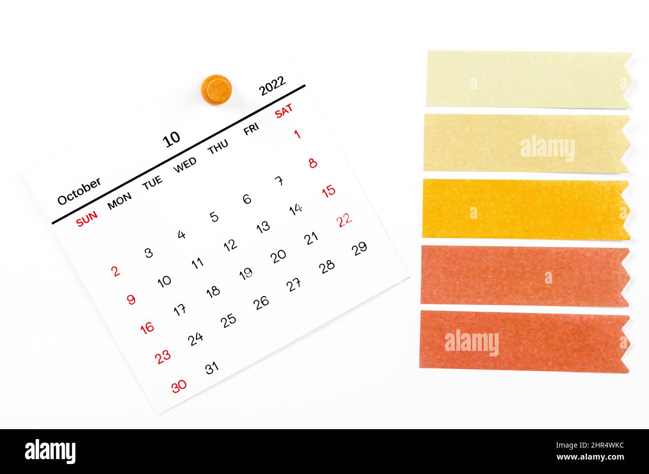 The October 2022 calendar with wooden push pin and blank adhesive note ...