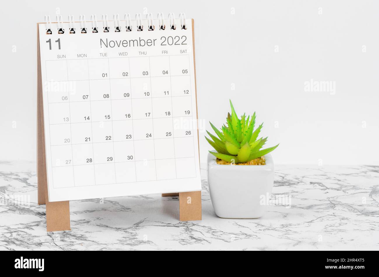 The November 2022 desk calendar with plant on marble table Stock Photo ...