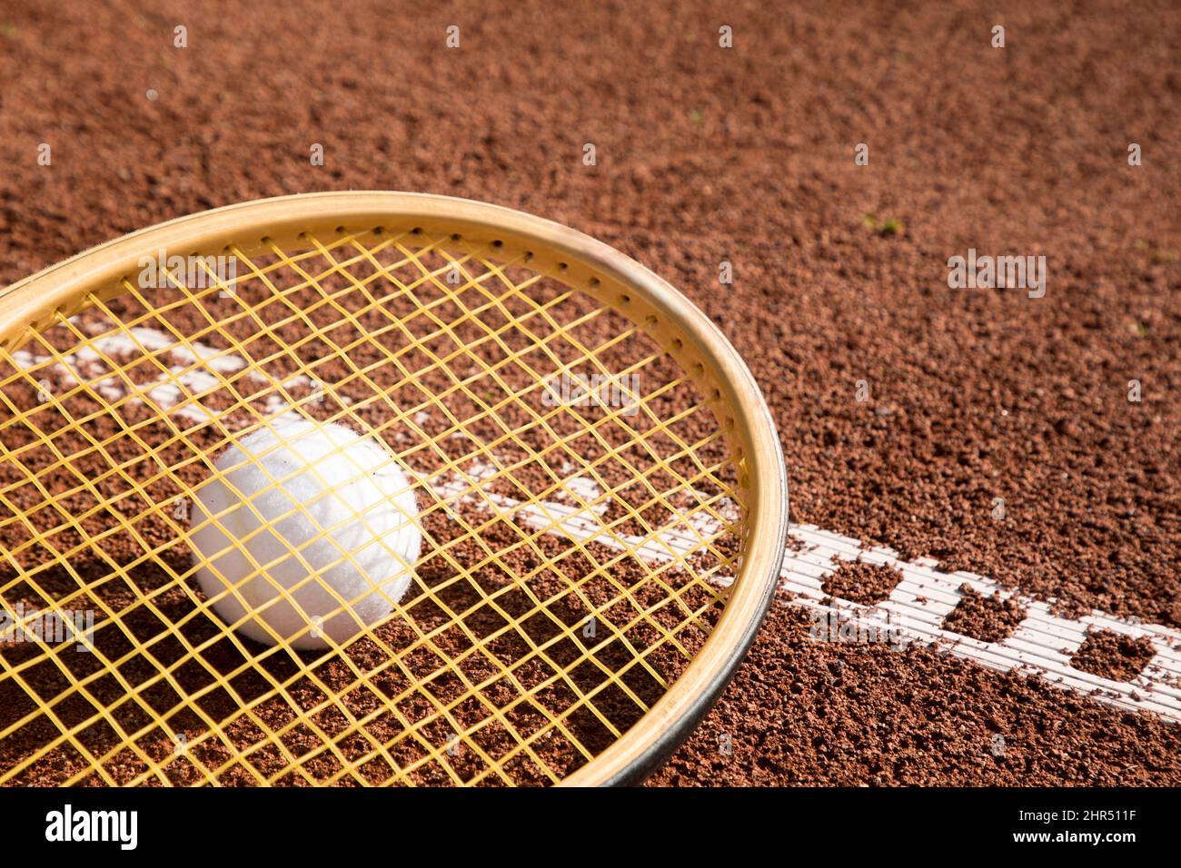 Tennis ball under a rocket in the court field Stock Photo - Alamy
