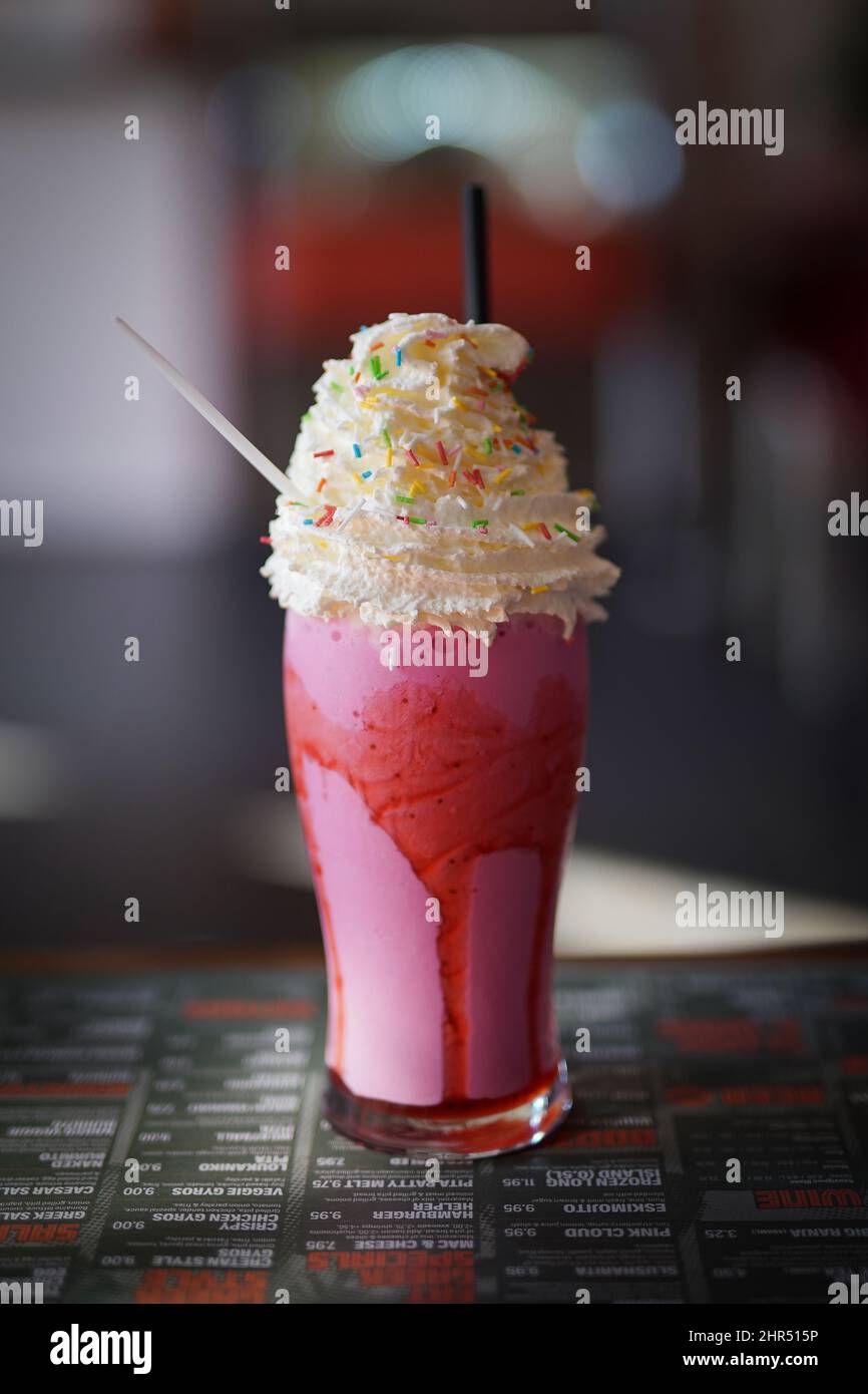 Vertical shot of a pink milkshake with whipped cream Stock Photo - Alamy