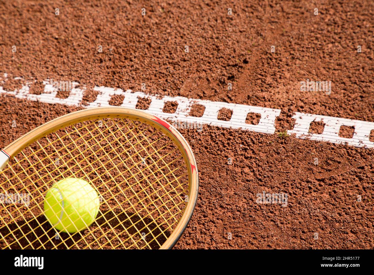 Tennis ball under a rocket in the court field Stock Photo - Alamy
