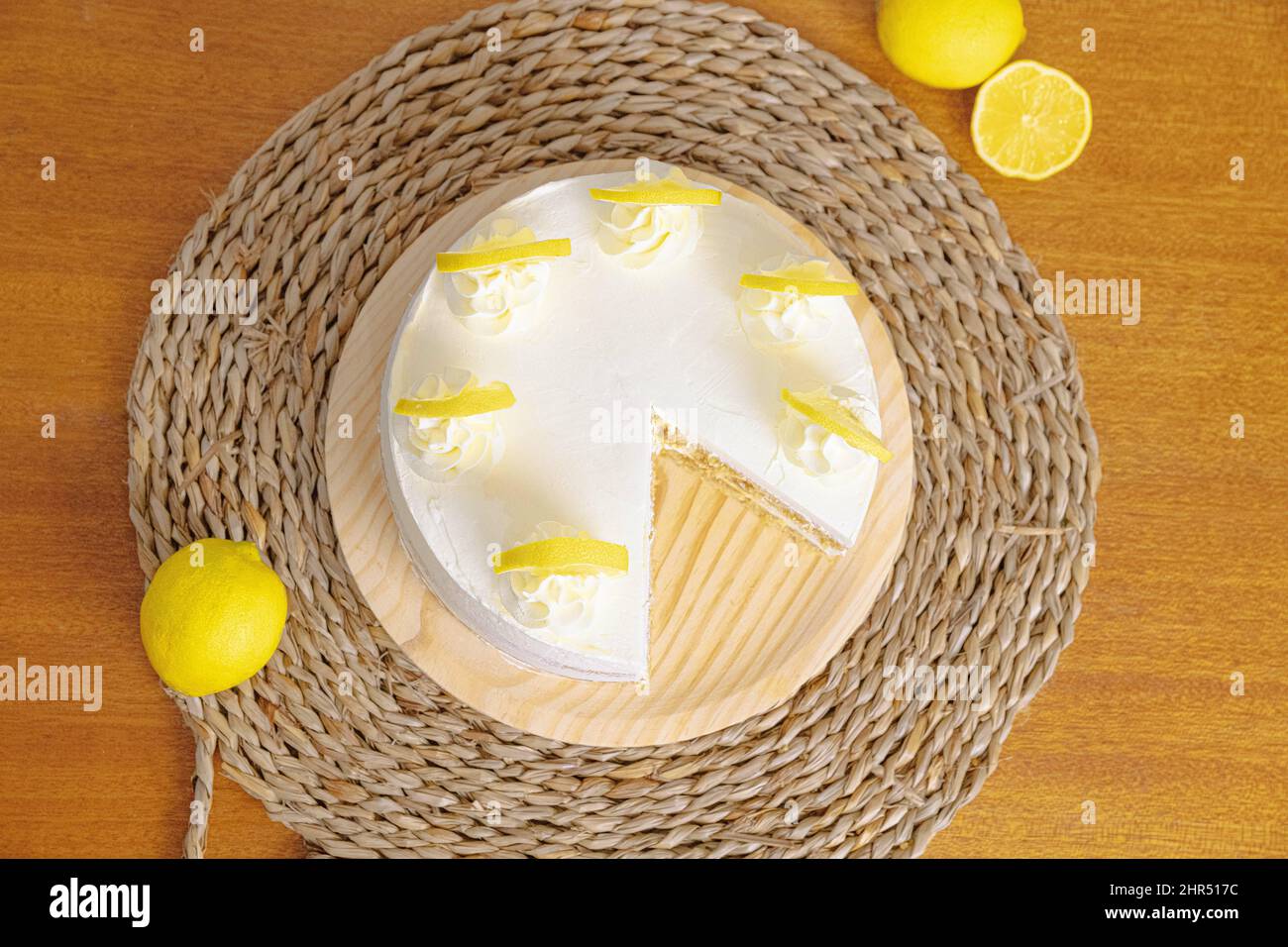 Top view of a sweet vanilla cake decorated with cream and the lemon ...