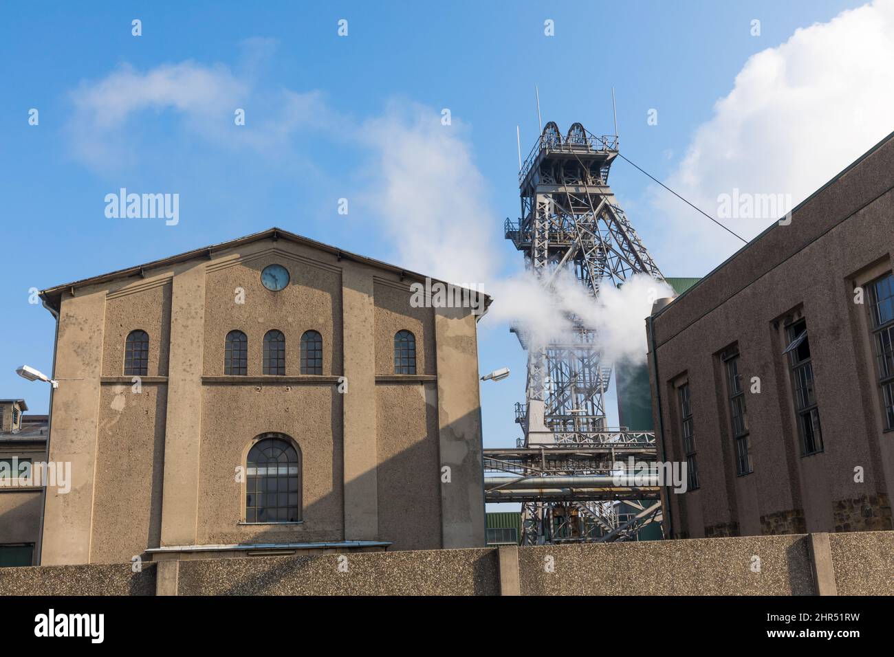 Mining building near a conveyor scaffolding against a blue sky Stock ...