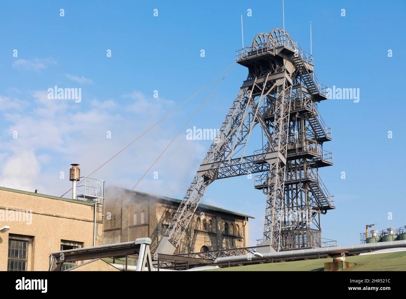 Mining building near a conveyor scaffolding against a blue sky Stock ...