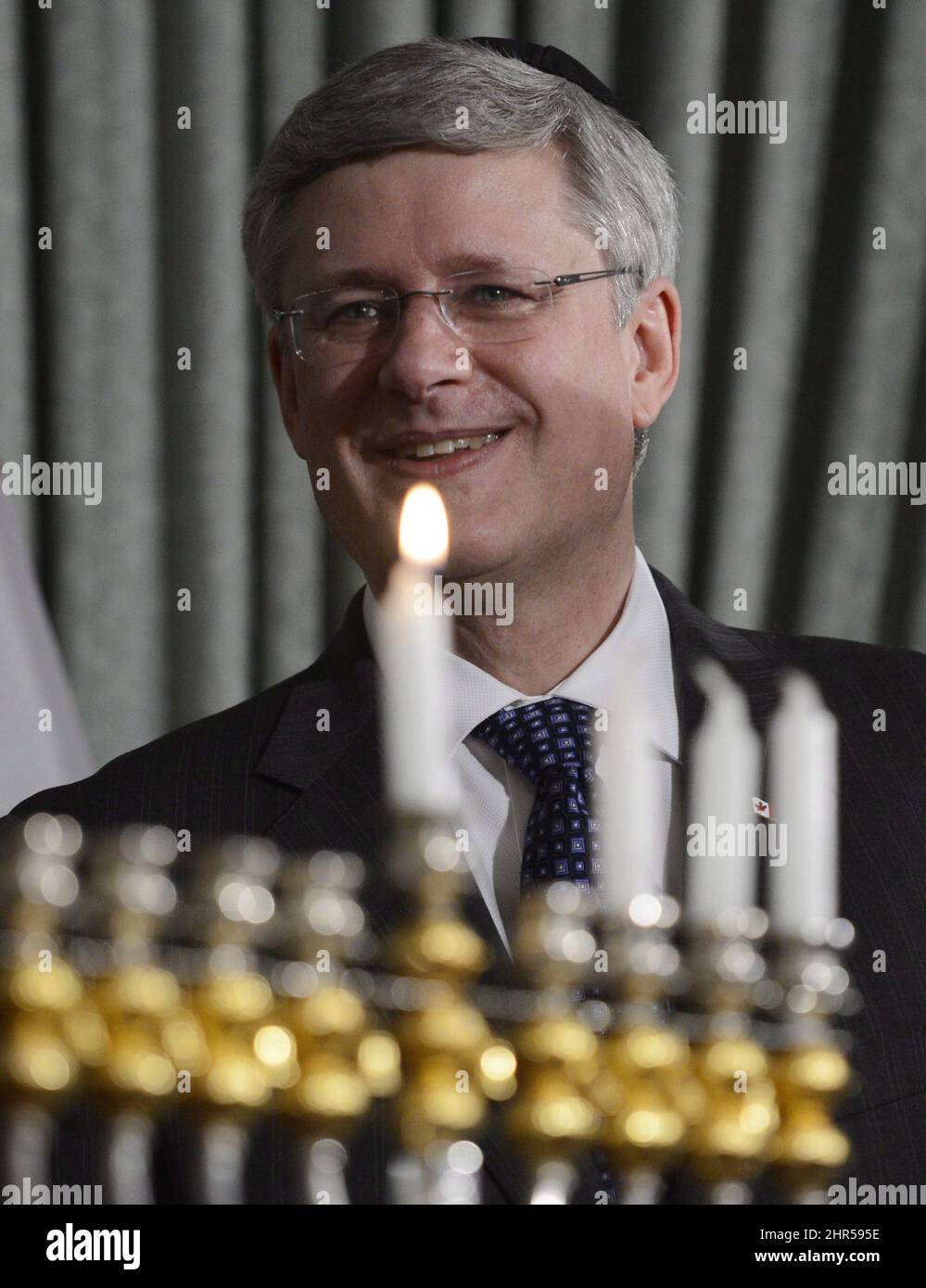 Canadian Prime Minister Stephen Harper takes part in a menorah lighting ...