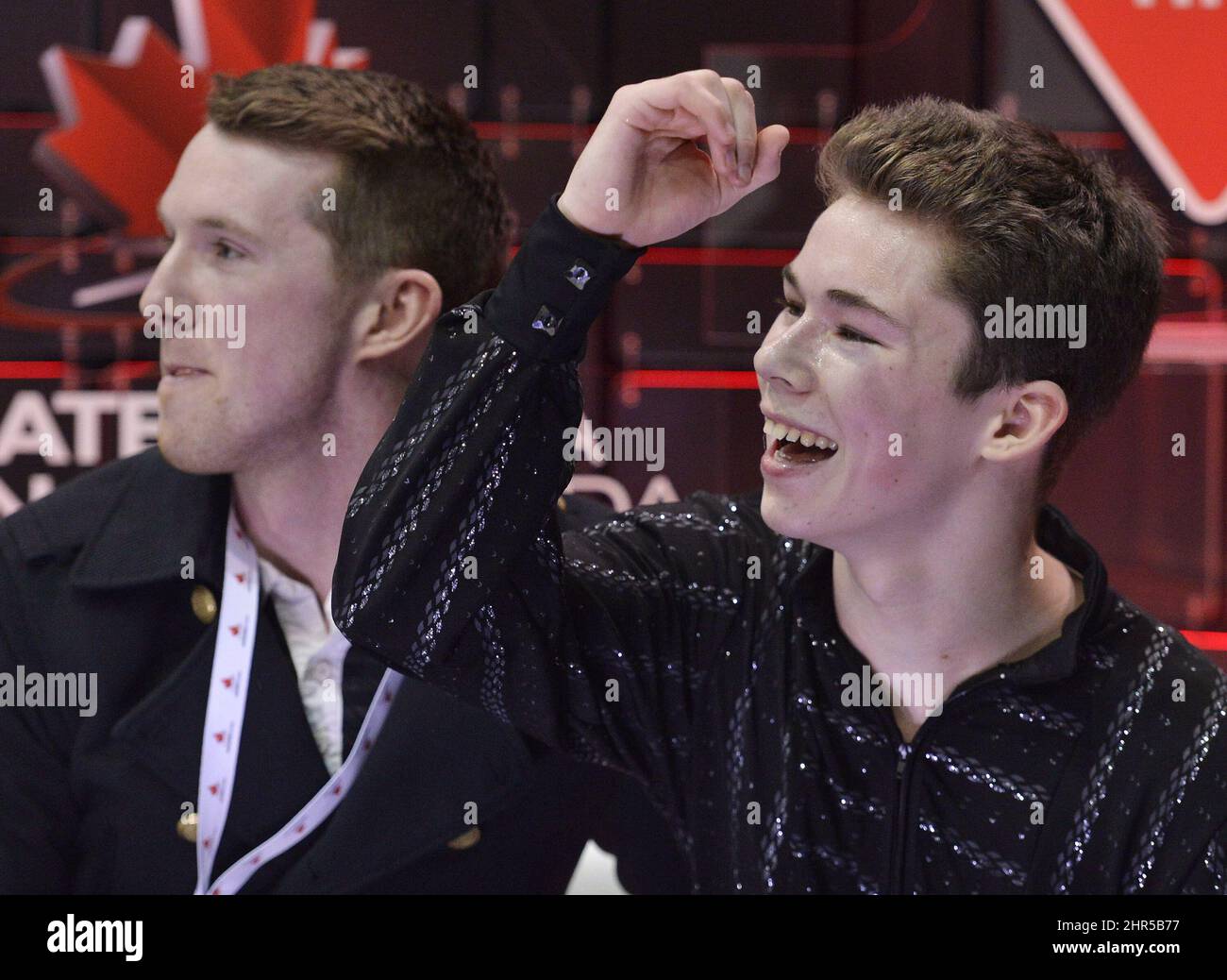 Mitchell Gordon, right, reacts after his results for his free program ...