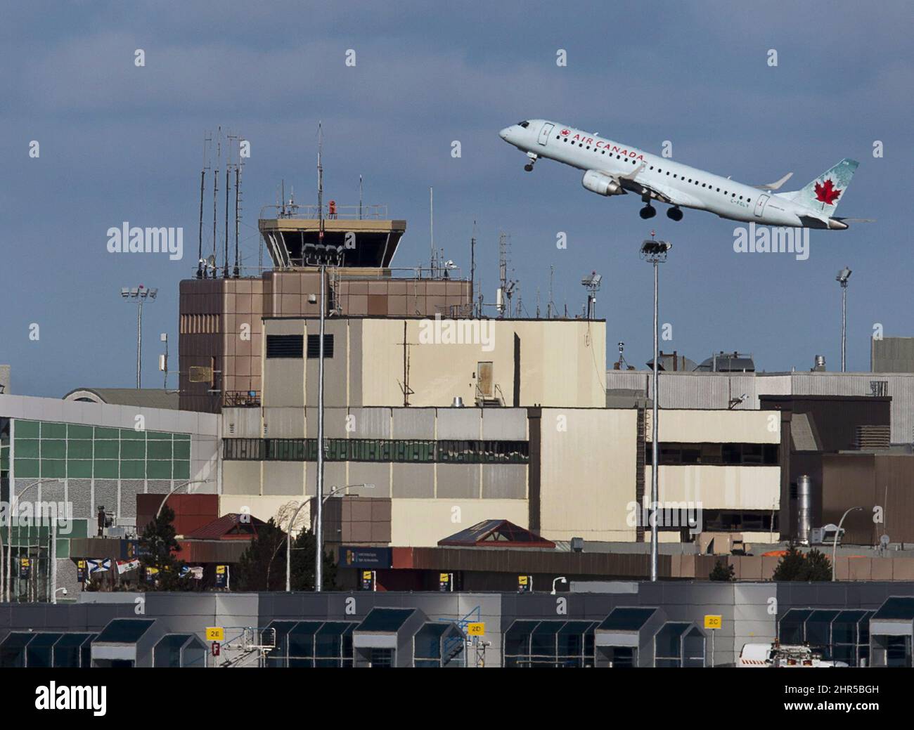 An Air Canada passenger jet takes off over the terminal at Halifax ...