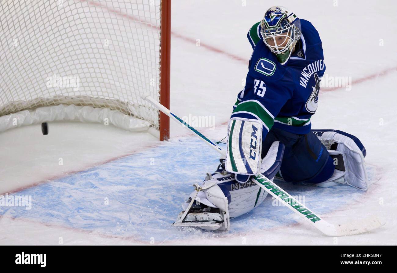 Vancouver Canucks goalie Cory Schneider allows a goal by Calgary Flames ...