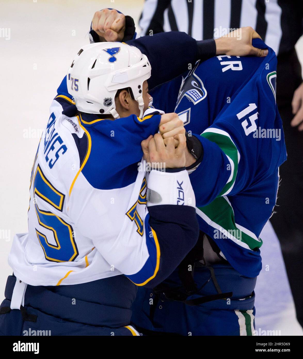 St. Louis Blues' Ryan Reaves, left, pulls Vancouver Canucks' Aaron ...