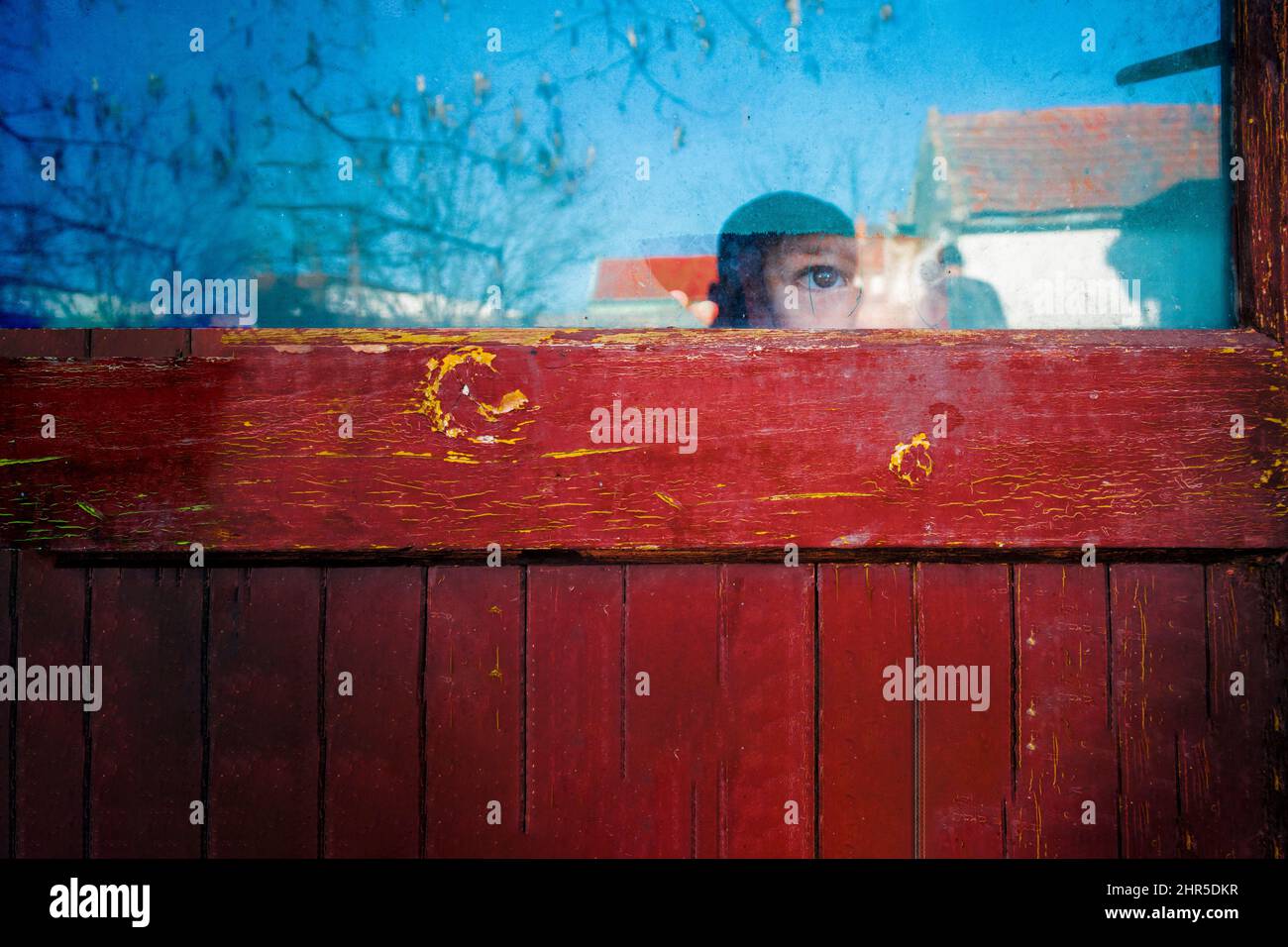 A child expressing fear watching outside Stock Photo - Alamy