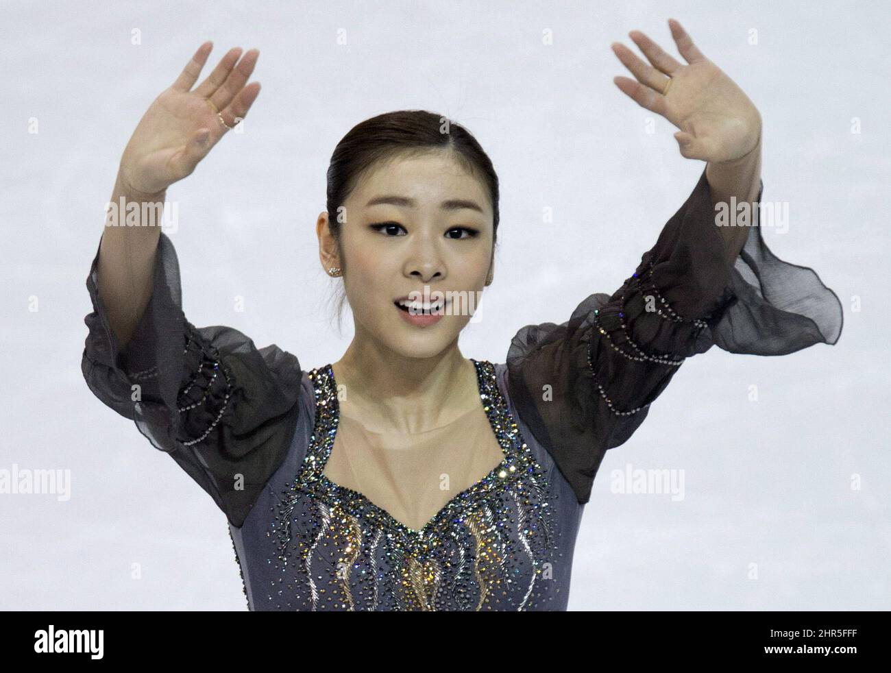 Yuna Kim of Korea waves to the crowd after performing in the ladies ...