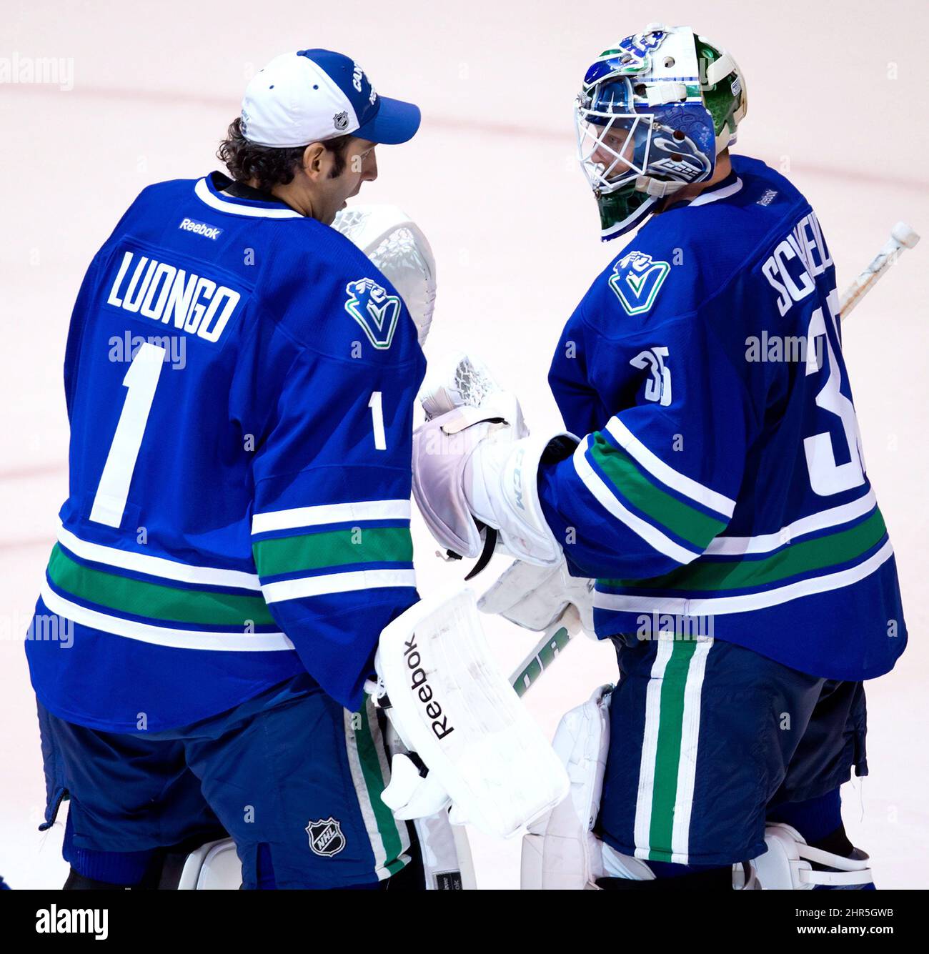 Vancouver Canucks' goalie Roberto Luongo, left, congratulates starting ...