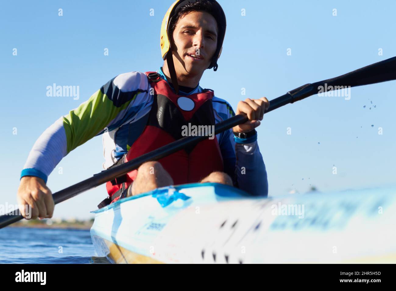 Ready to row. Shot of a young man kayaking in a river Stock Photo - Alamy