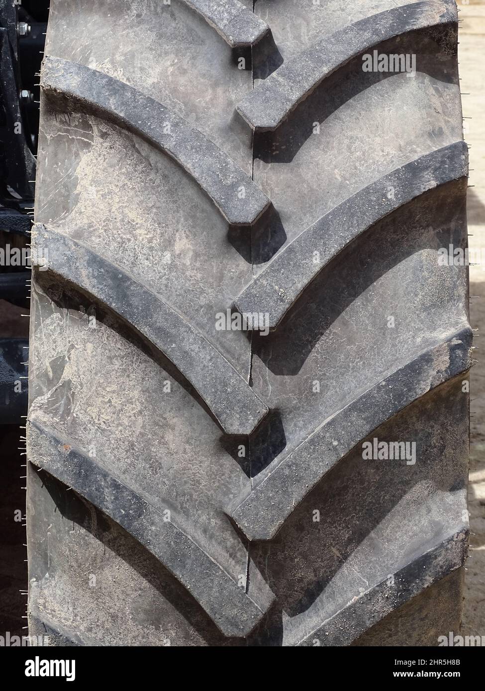 macro of the profile of a very large tire of a wheel, with colors black ...
