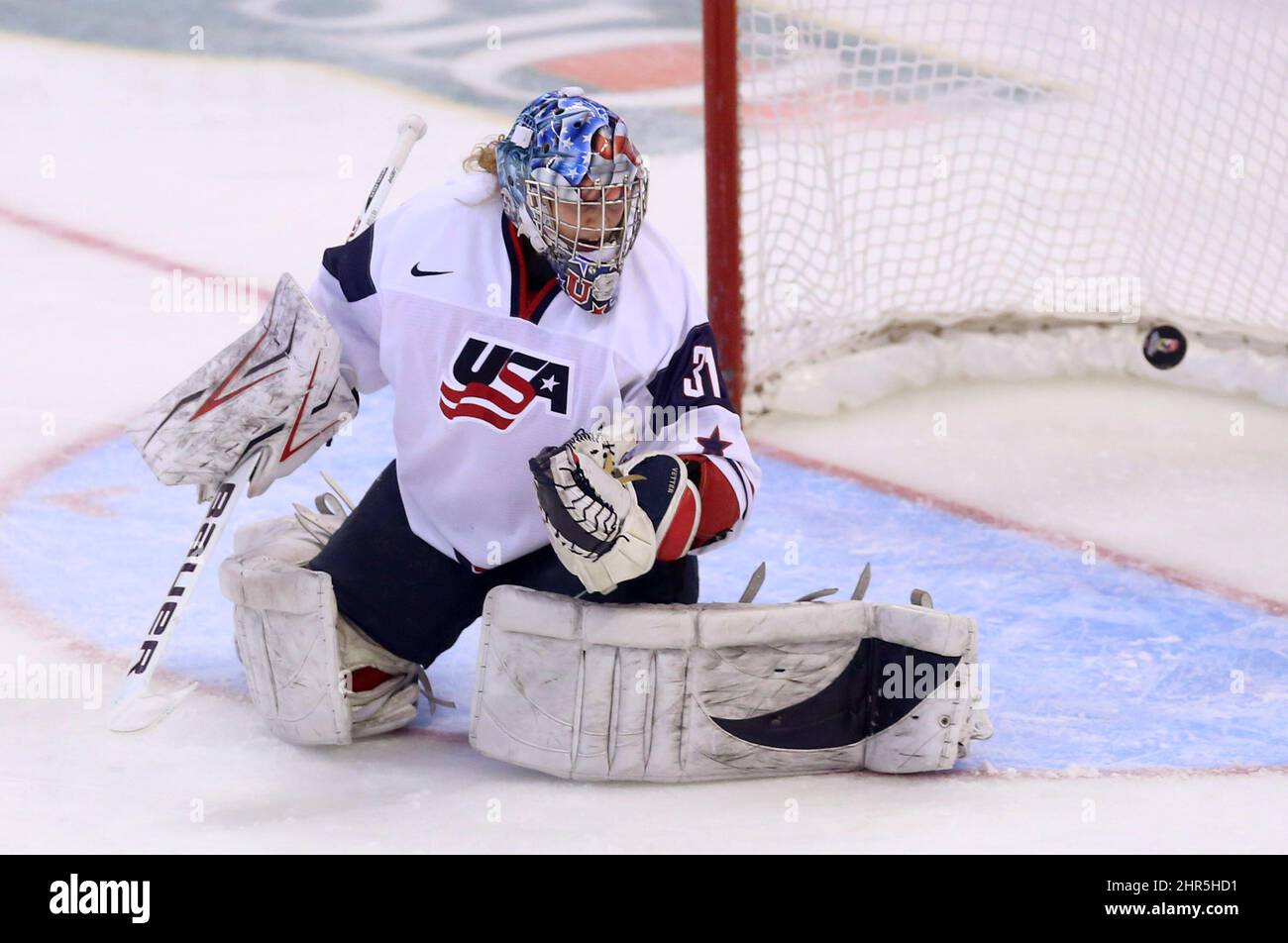 The puck sails past Team USA goalie Jessie Vetter as Team Canada's ...