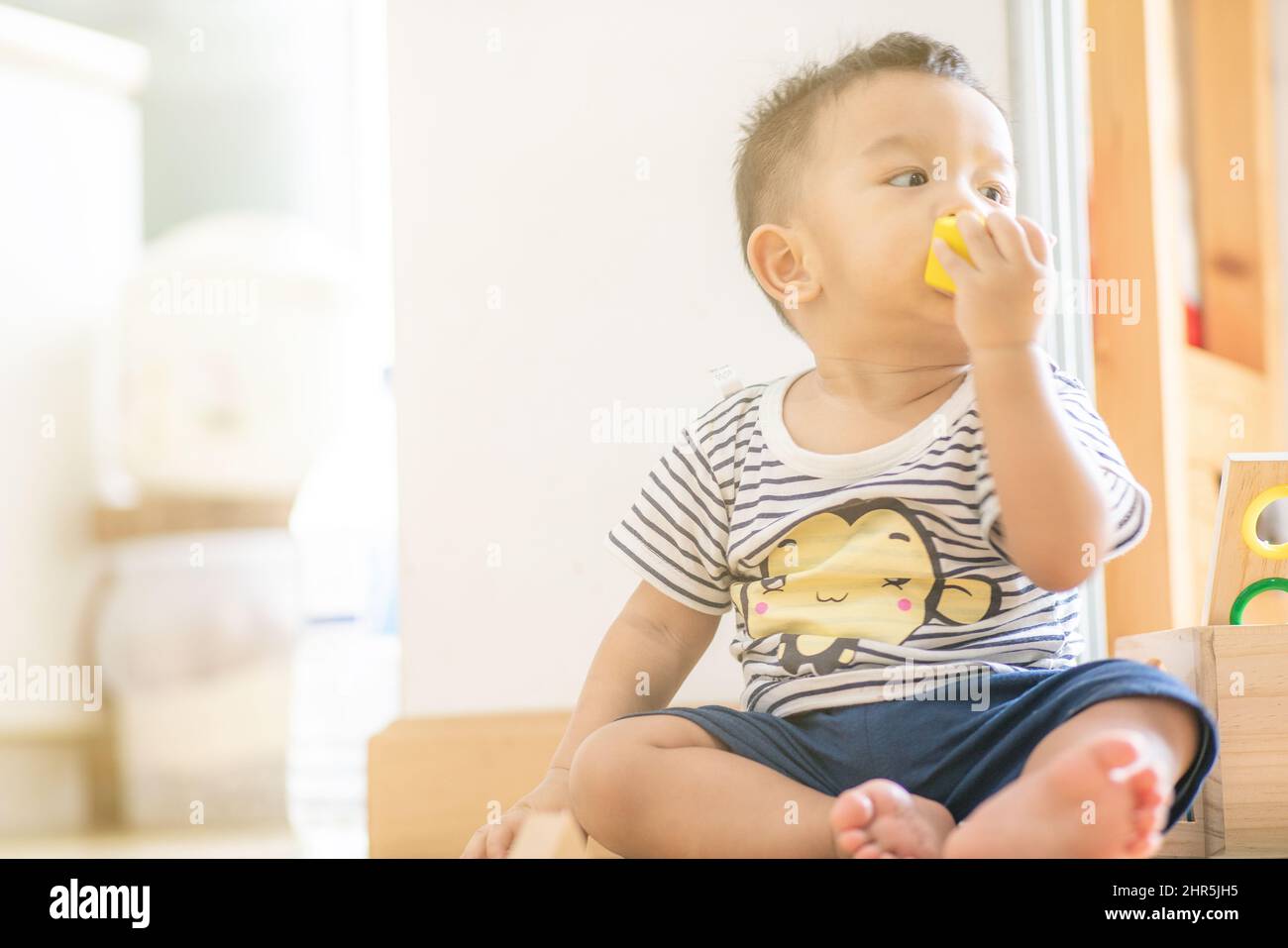 Adorable toddler baby boy with snack food in home, Funny boy education ...