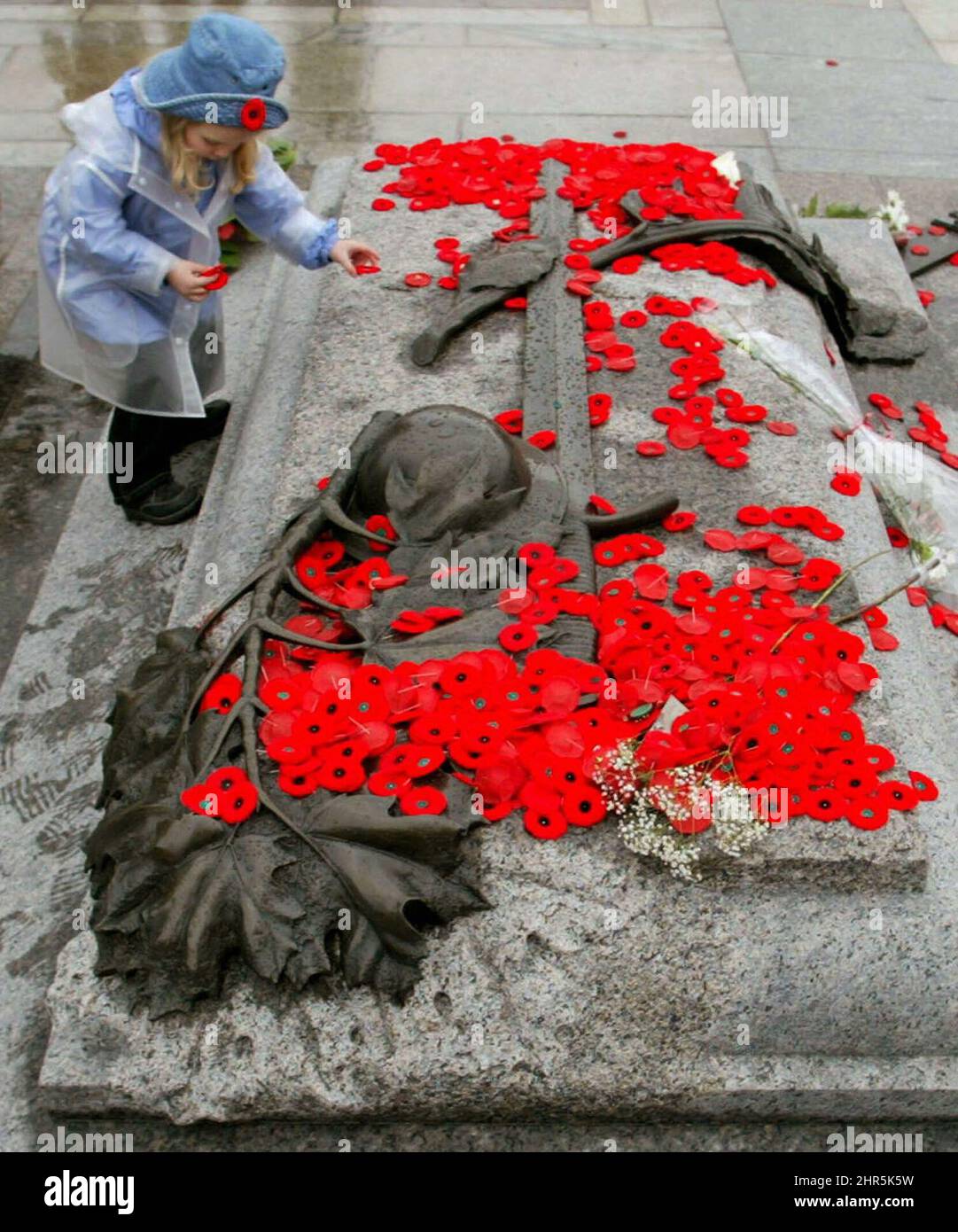 PA PHOTOS/CP - UK USE ONLY: Danielle Provost puts a poppy on the tomb ...