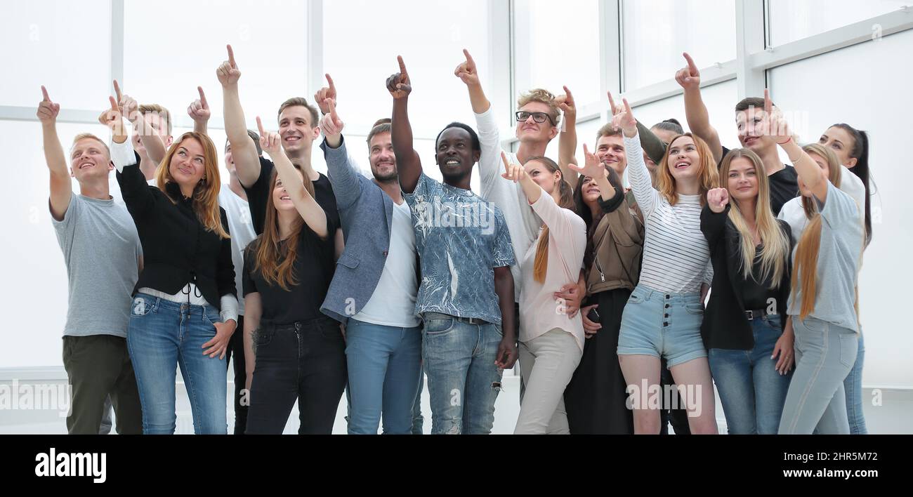 group of happy young people pointing upwards Stock Photo - Alamy