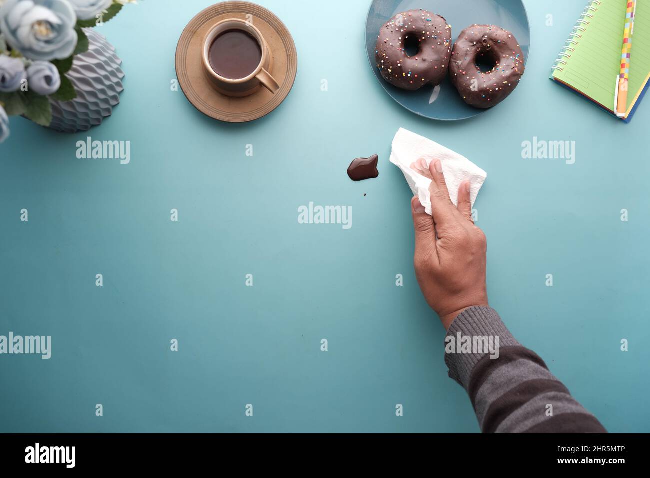 top view of person hand cleaning chocolate spilling with tissue Stock ...