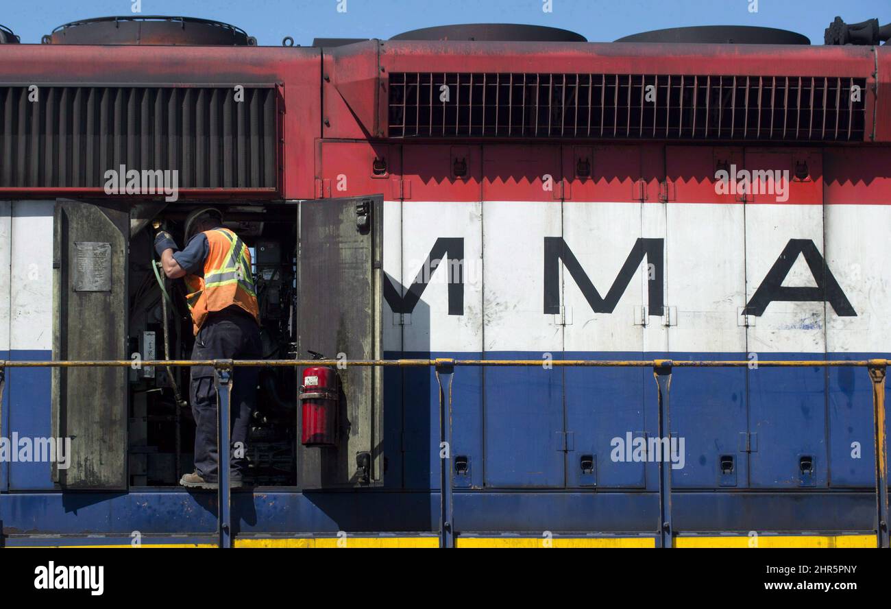 An engineer checks the engine of a Montreal Maine and Atlantic ...