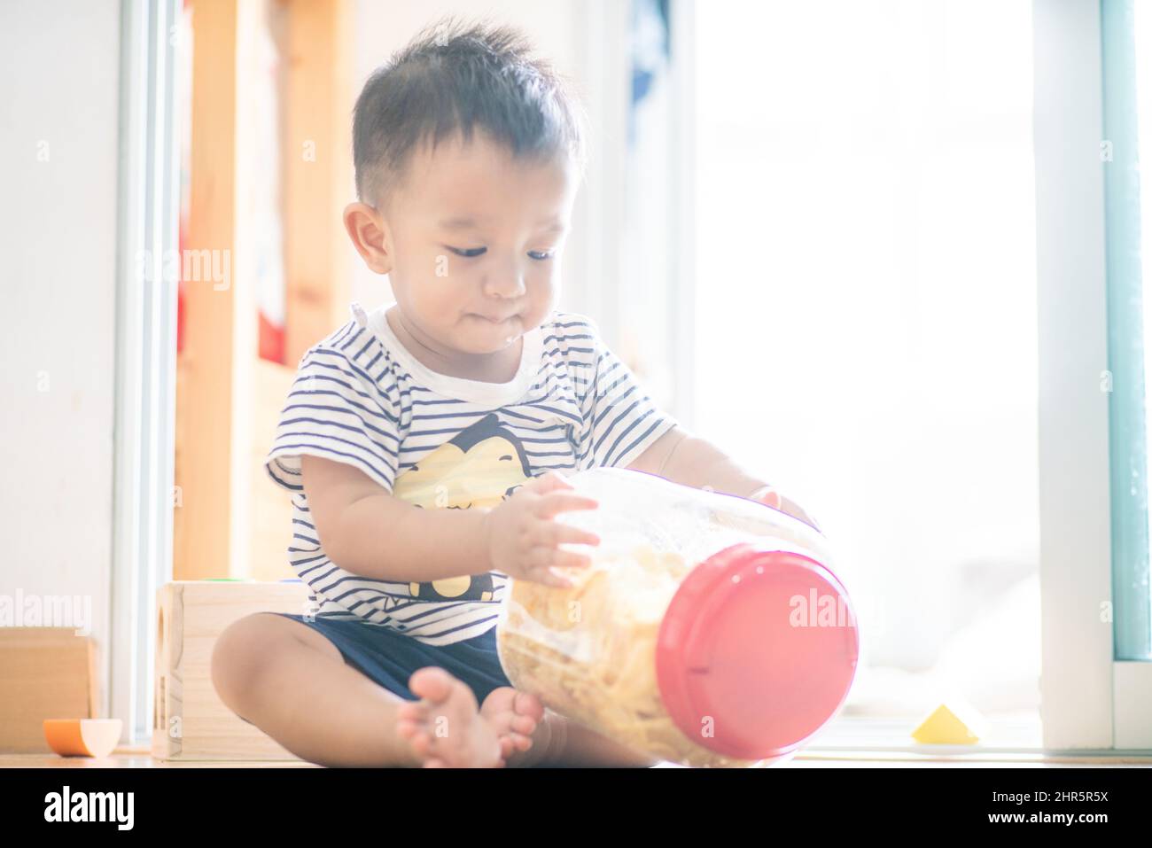 Adorable toddler baby boy with snack food in home, Funny boy education ...