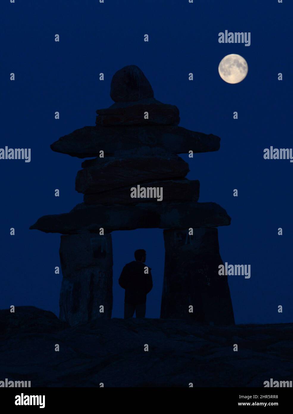 Cory McFarlane of Winnipeg checks out a giant inuksuk in Rankin Inlet ...