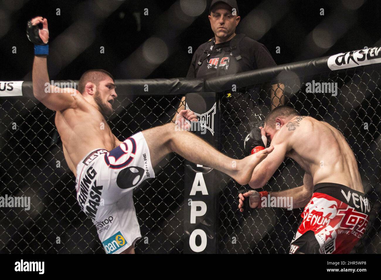 Russia's Khabib Nurmagomedov (left) lands a kick on American Pat Healy ...