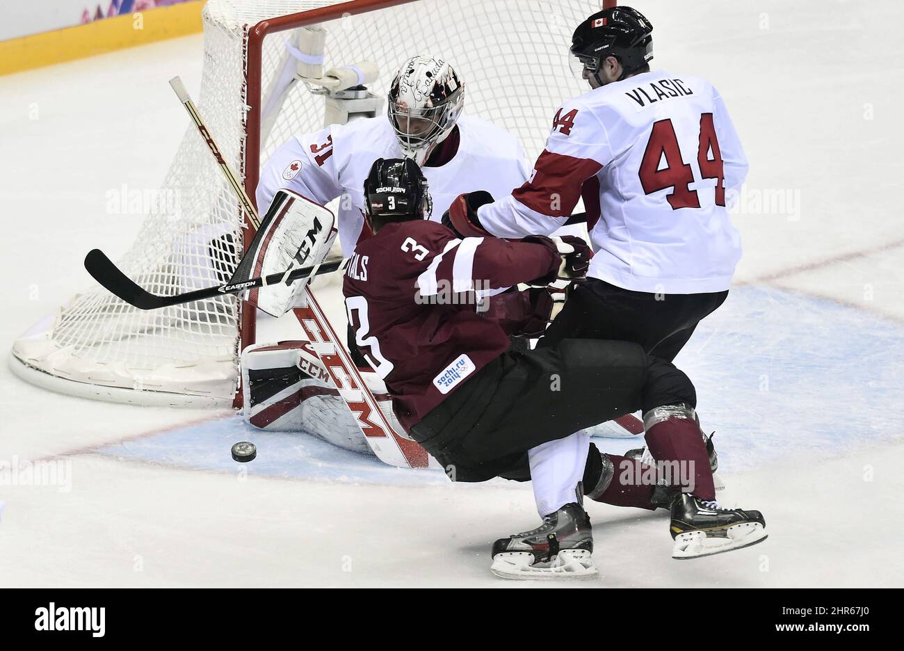 Canada goalie Carey Price makes a save as teammate Marc-Edouard Vlasic ...