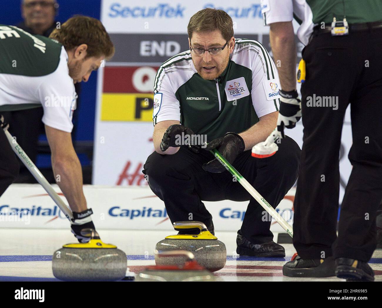 Prince Edward Island skip Eddie MacKenzie directs Anson Carmody, left ...