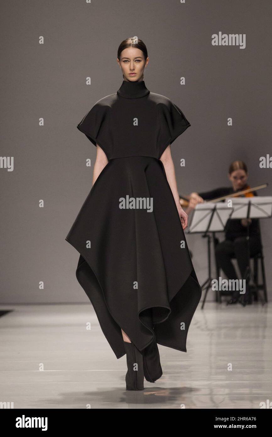 A model shows a creation from Sid Neigum while walking the runway ...