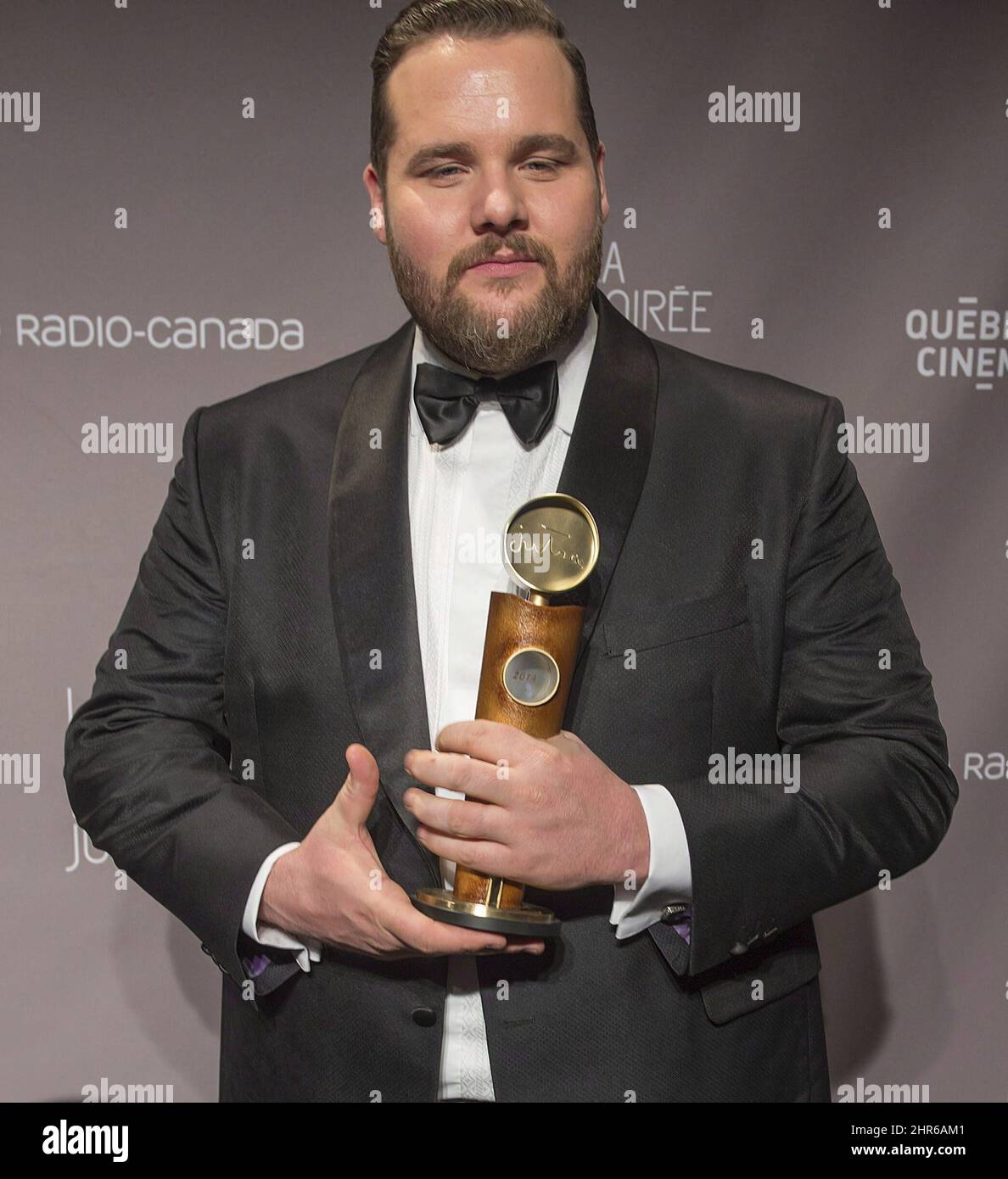 Best Actor winner Antoine Bertrand poses backstage with his trophy at ...