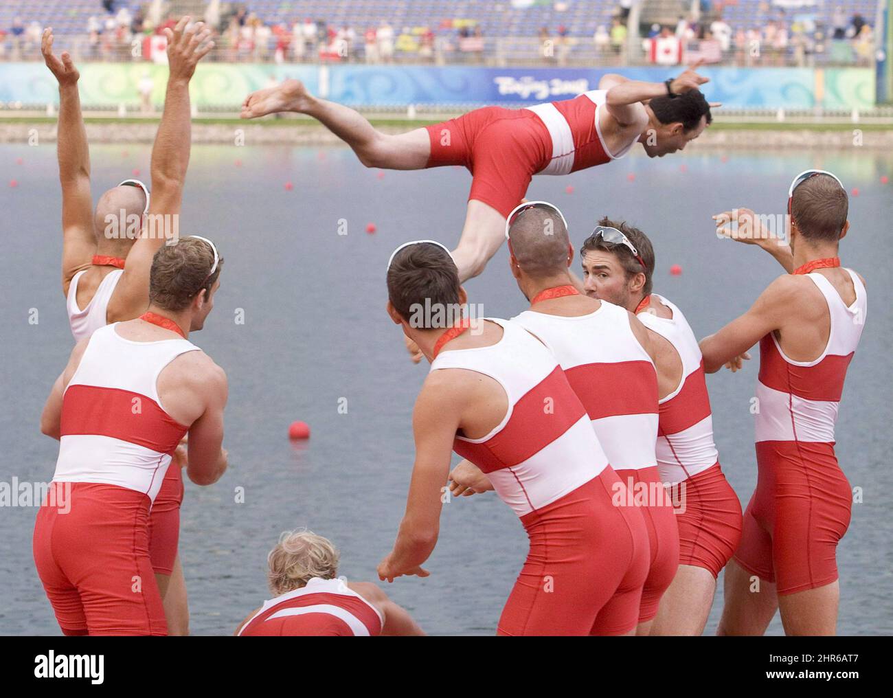 Canada's men's eight team throw coxswain Brian Price into the water ...
