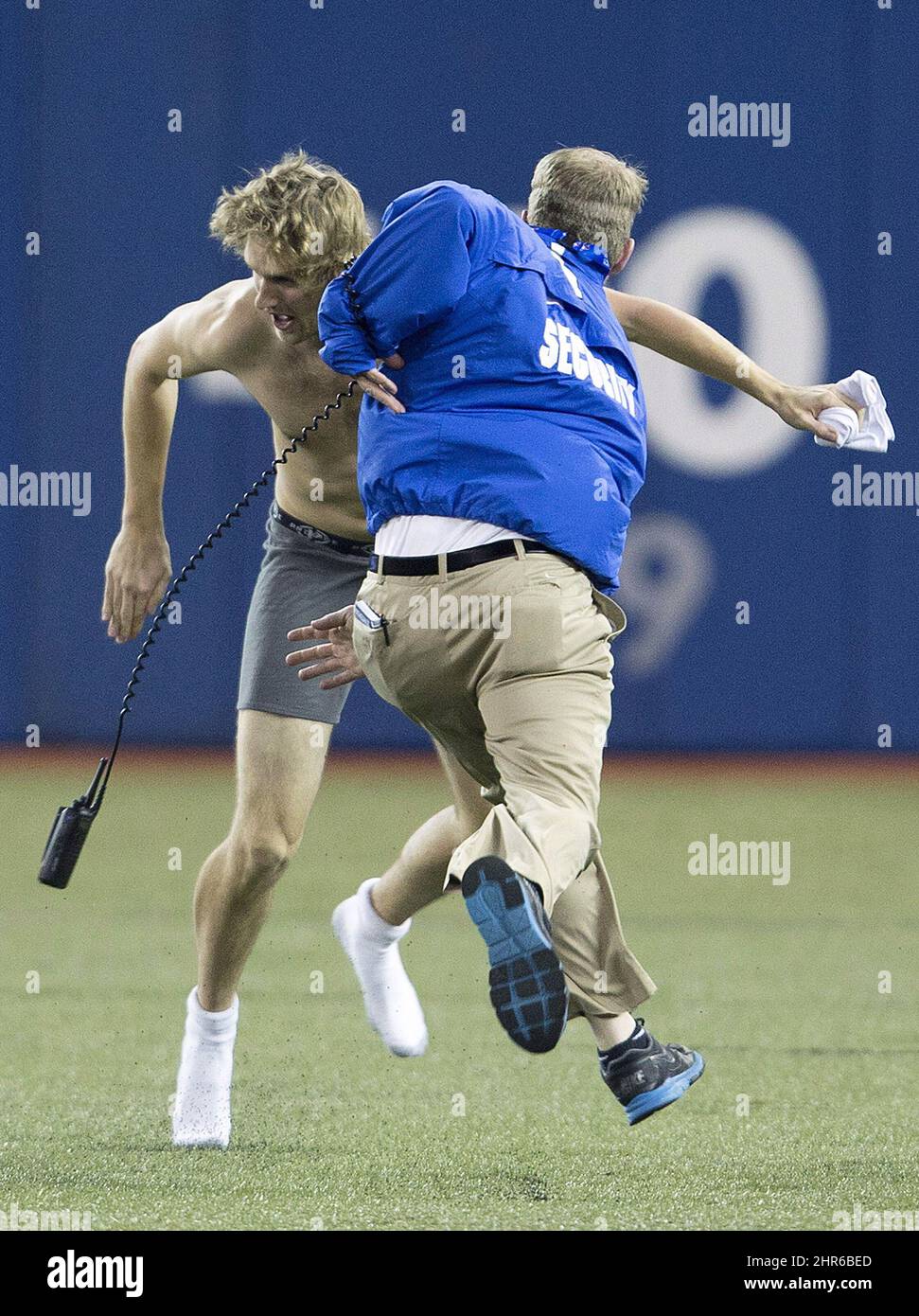 A security guard chases down a streaker on the field as the Toronto ...
