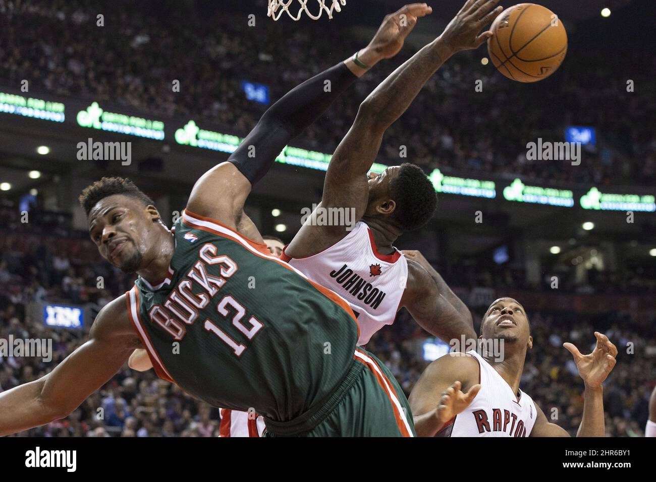 Toronto Raptors' Amir Johnson (centre) battles for the ball with ...