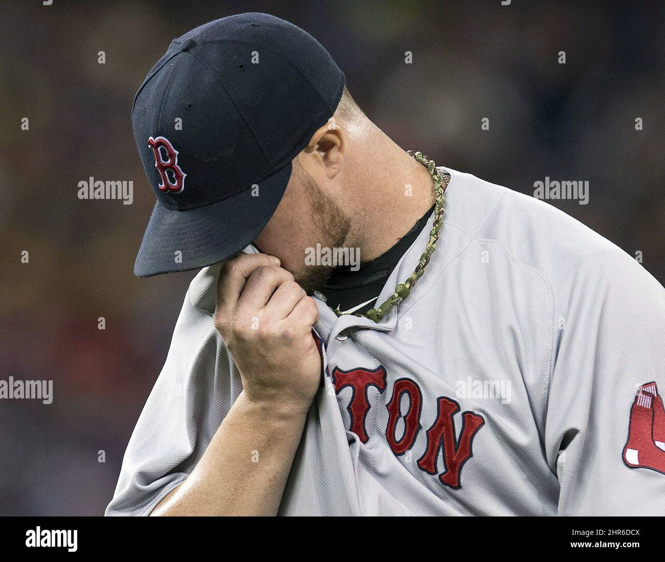 Boston Red Sox starting pitcher Jon Lester walks off the field during ...