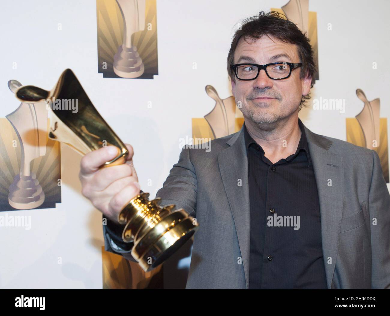 Claude Legault holds his trophy for best actor in a television series ...
