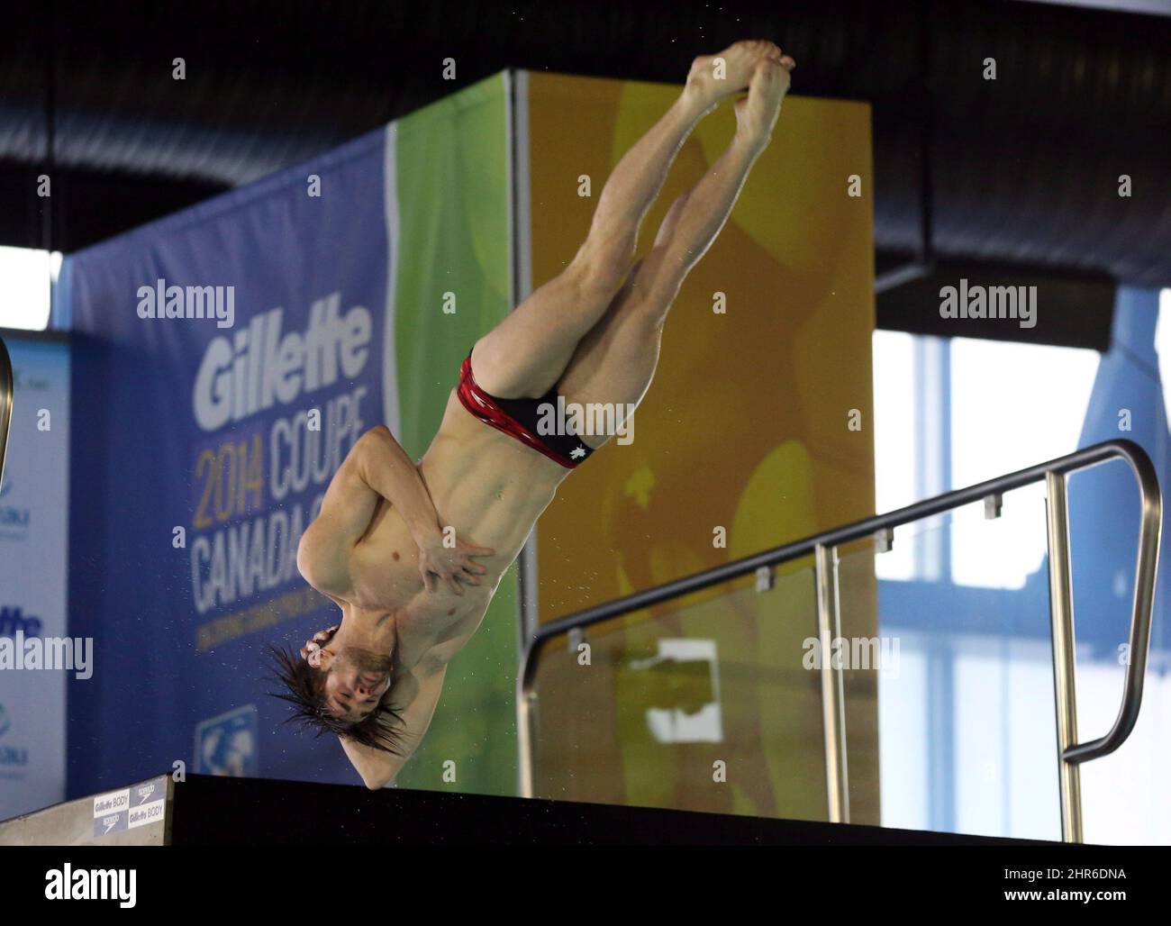 Maxim Bouchard, of Canada, performs a dive in the men's 10m platform ...