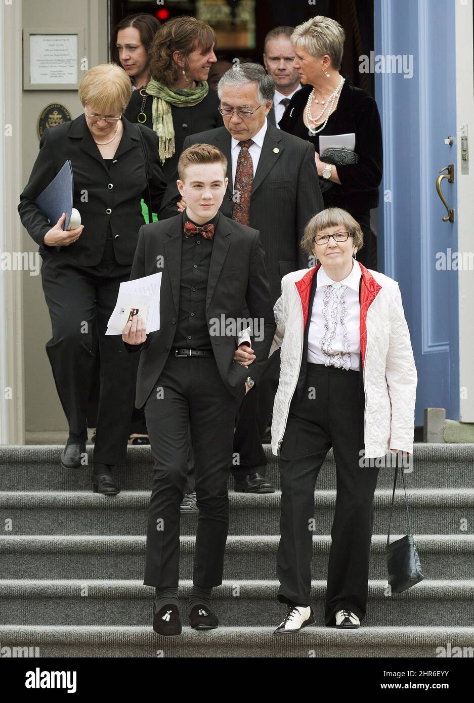 Widow Claire Mowat, right, and her grandson Justin Mowat, left, follow ...