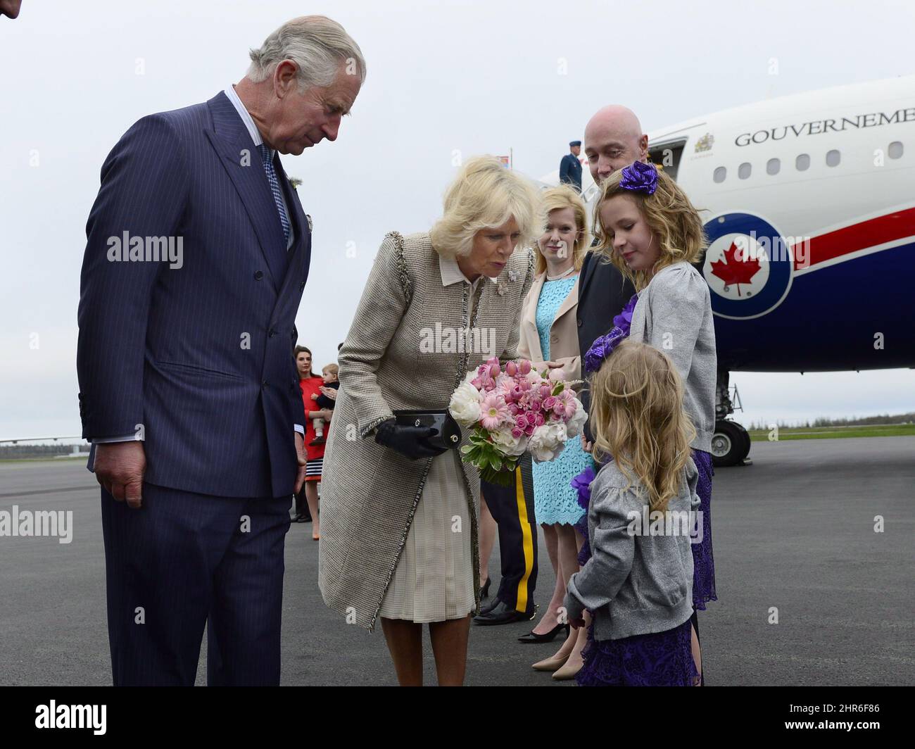 Prince Charles and his wife Camilla receive flowers from Miss Grace ...
