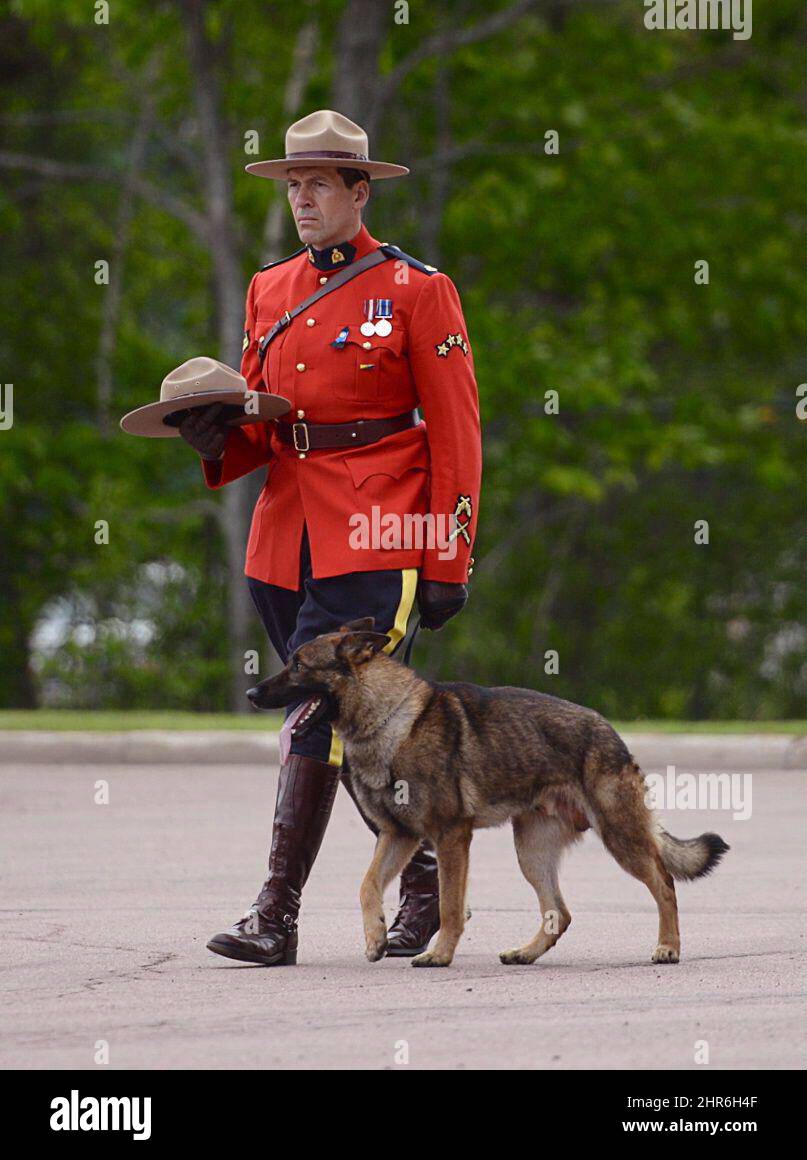 An officer holds the hat Const. Dave Joseph Ross as he walks with Ross ...