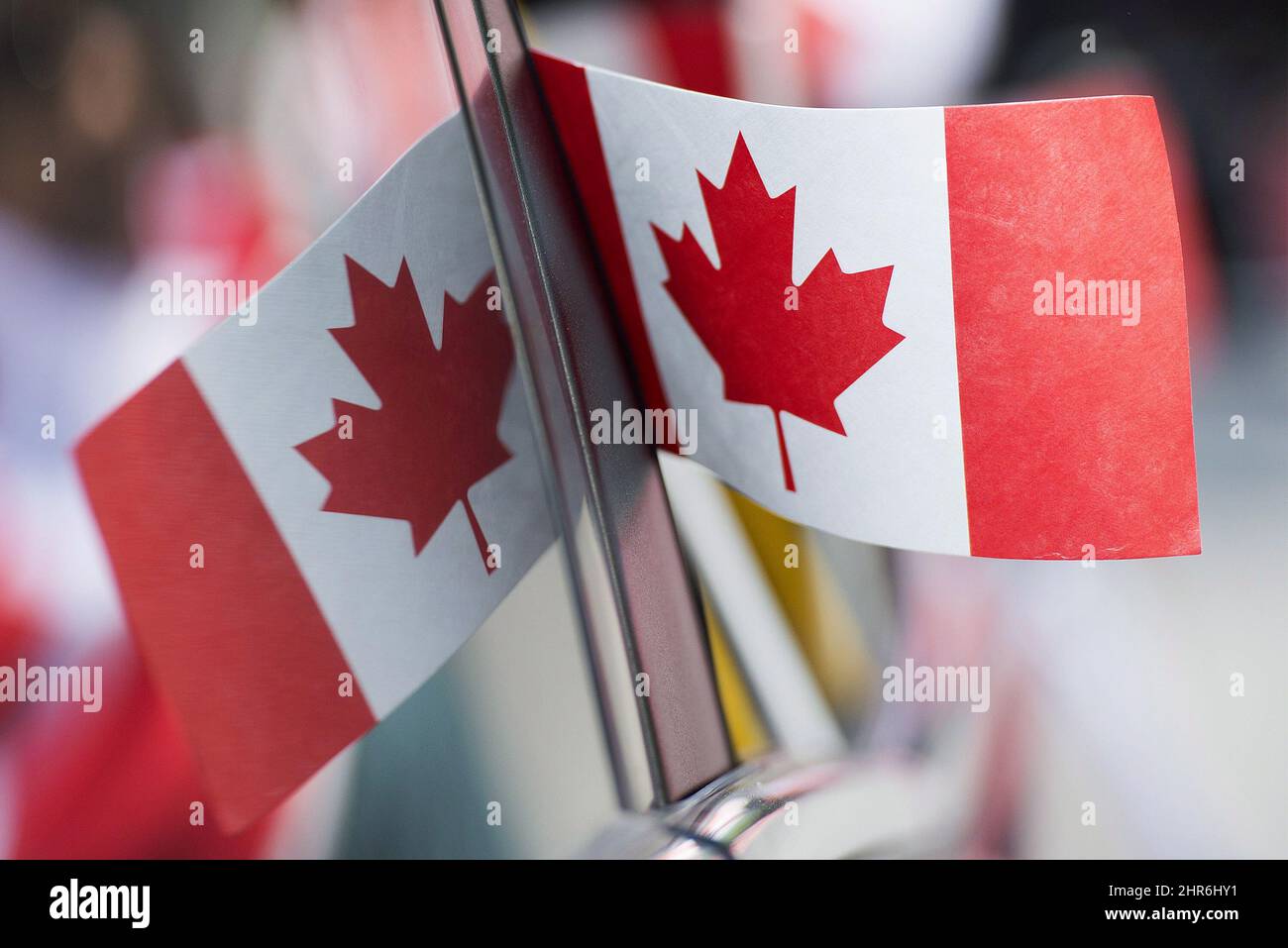 A Canadian flag is reflected in a car window during the annual Canada ...