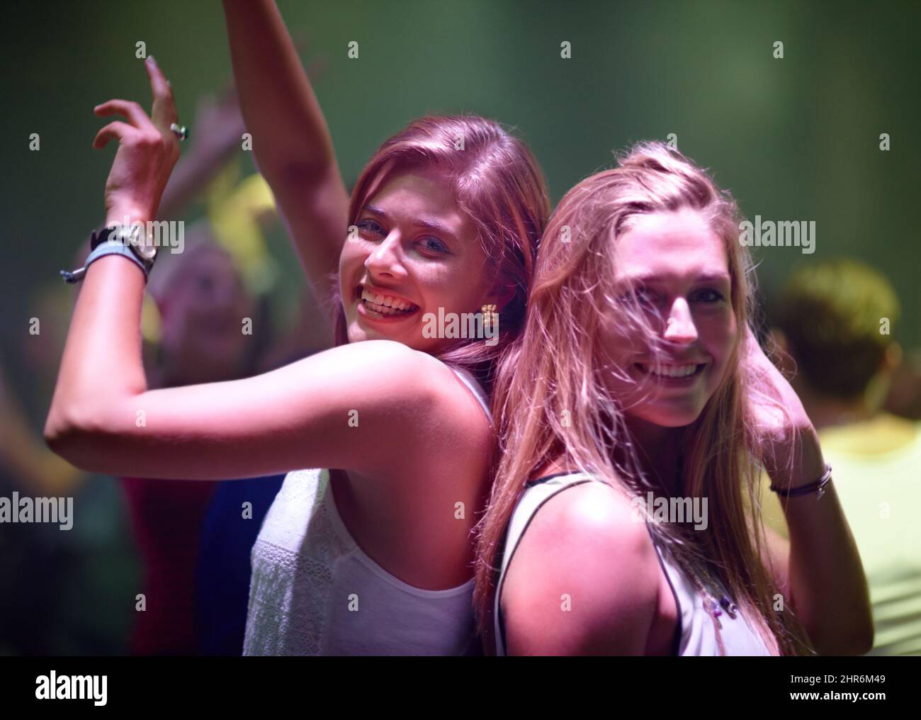 Letting loose at the club. A pretty young woman partying it up with ...