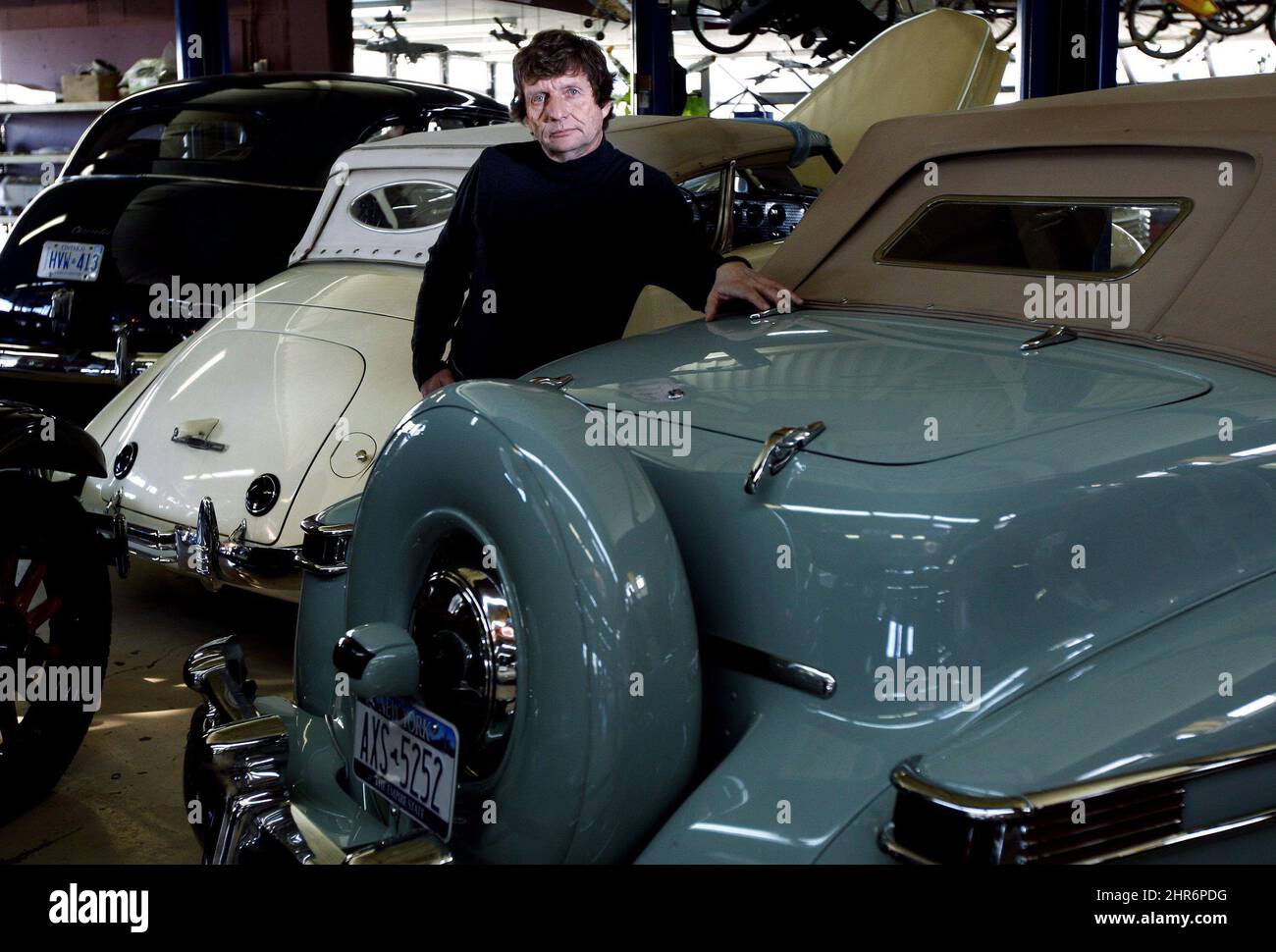 Owner David Grainger poses with some of his restored classic antique ...