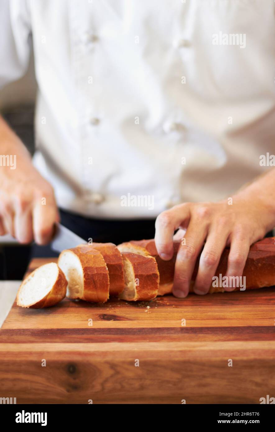 Presentation is everything. A baker cutting up french bread Stock Photo ...